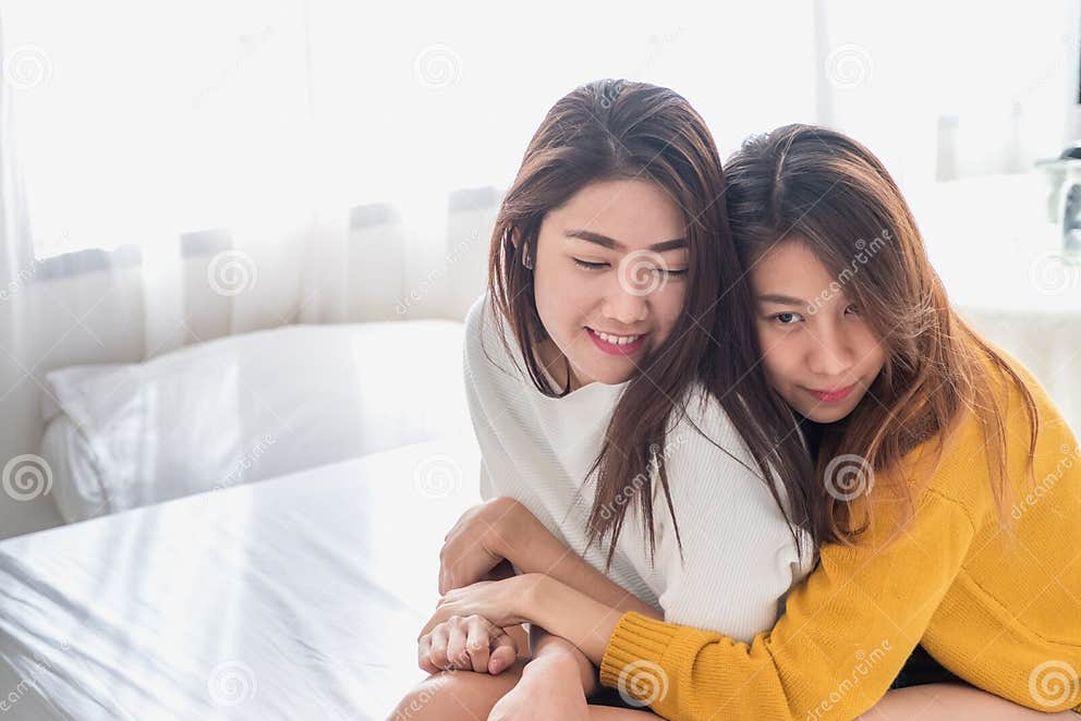 Asia Lesbian Lgbt Couple Hug And Sitting On Bed Near White Window