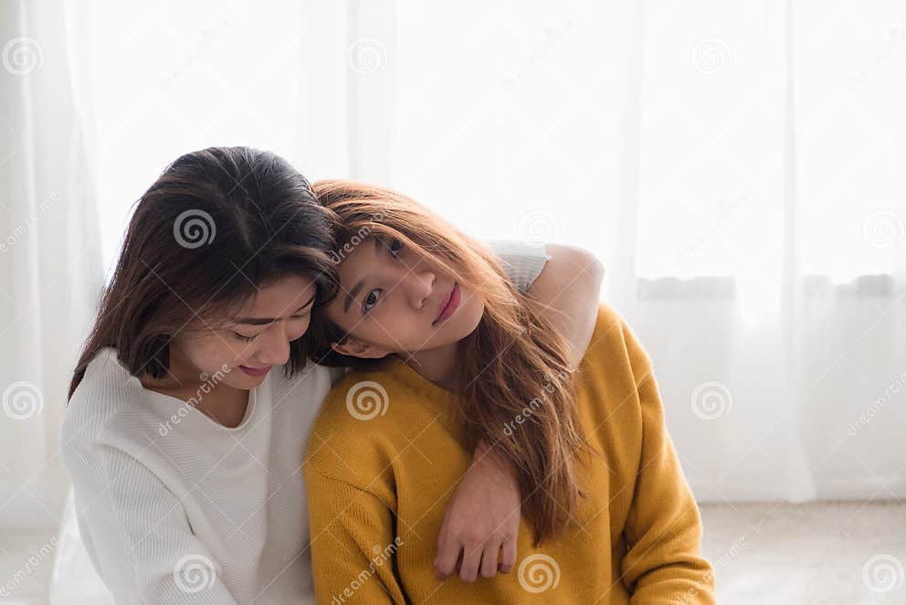 Asia Lesbian Lgbt Couple Hug And Sitting On Bed Near White Window
