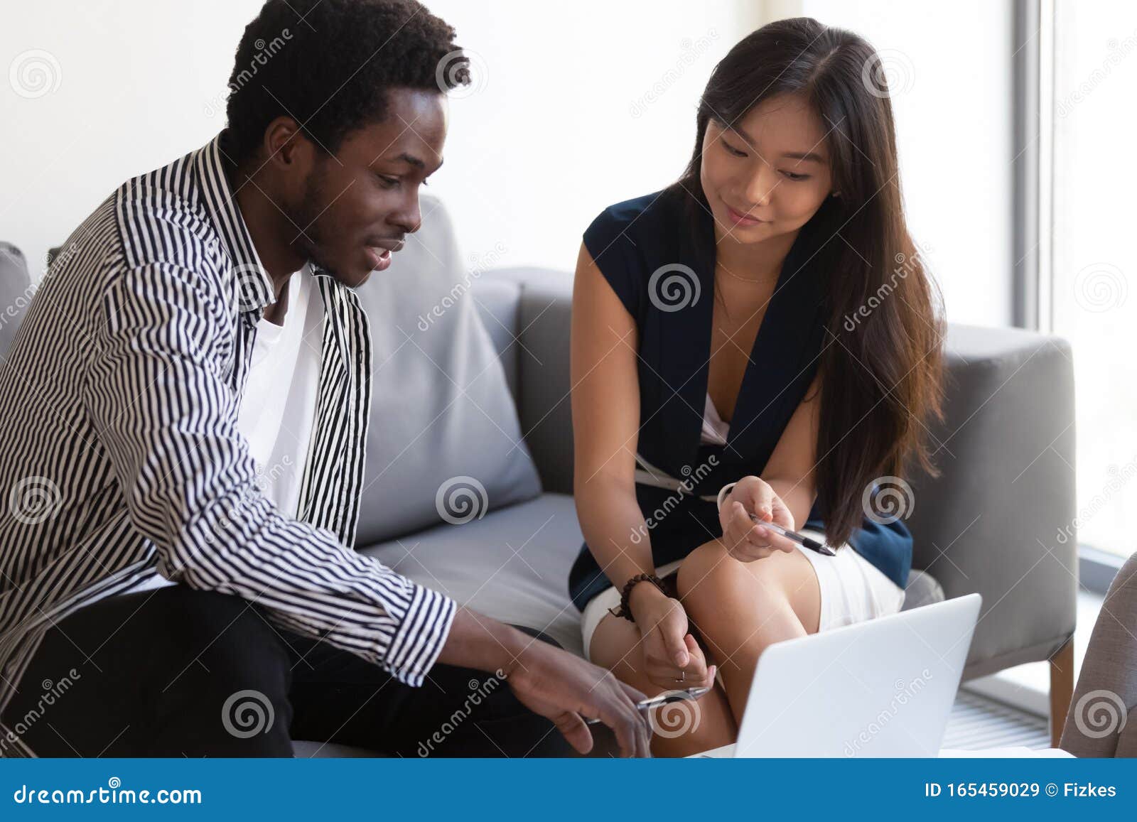 Asian African Colleagues Using Business Application on Computer Working ... Asian African Colleagues Using Business Application on Computer Working ...