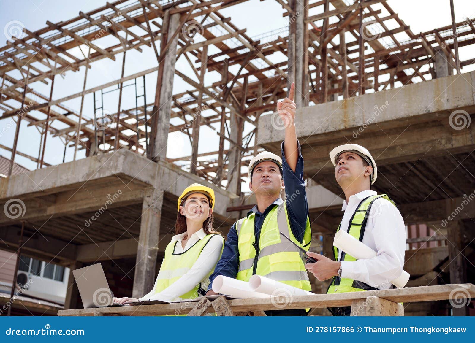 Asian Architector and Engineers Team with Draft Plan of Building and ...