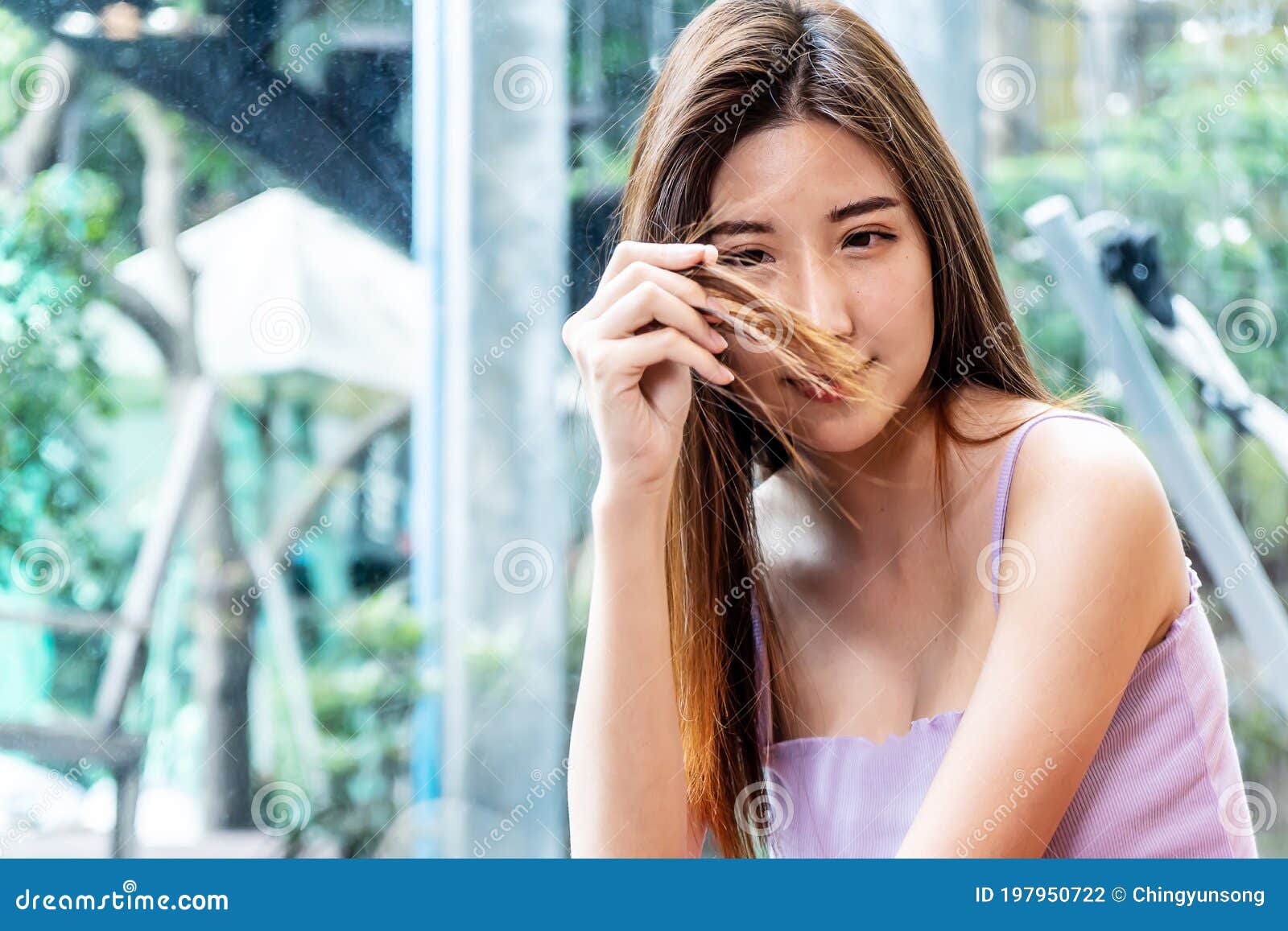 Asian Beautiful Young Woman Hand Holding Her Long Hair With Looking