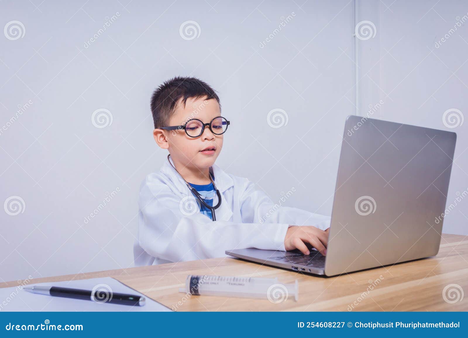Asian Boy Doctor Using a Laptop Computer Stock Image - Image of ...
