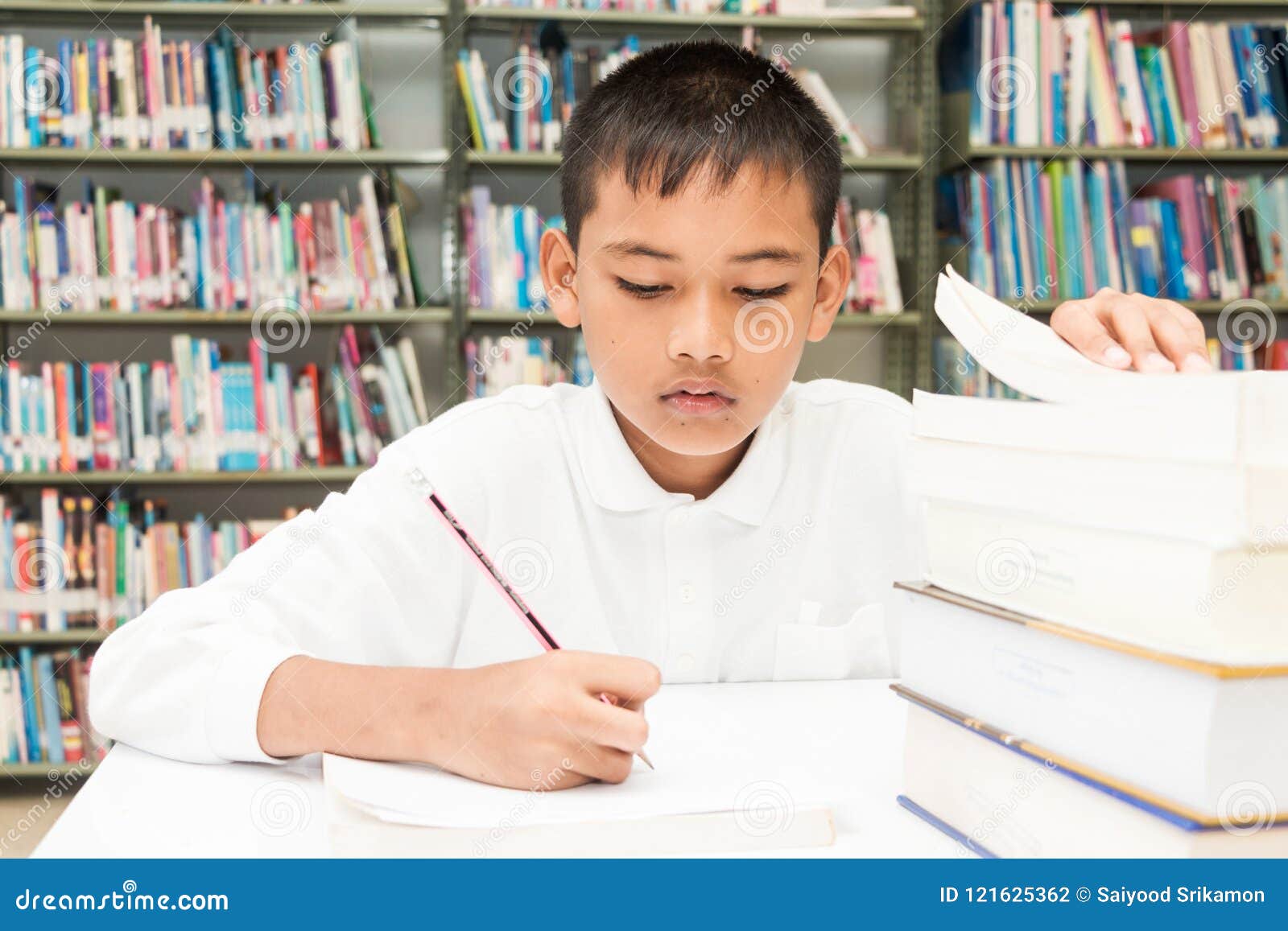 Asian boy doing homework . stock photo. Image of desk - 121625362