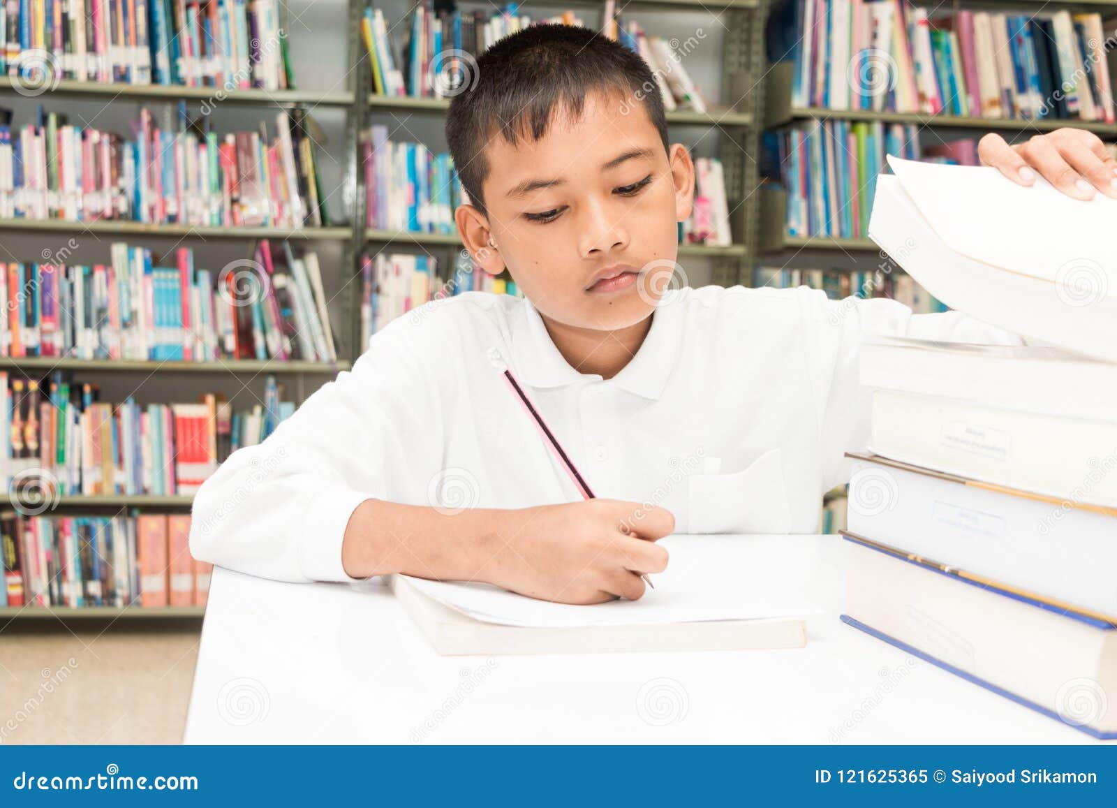 Asian boy doing homework . stock image. Image of concept - 121625365