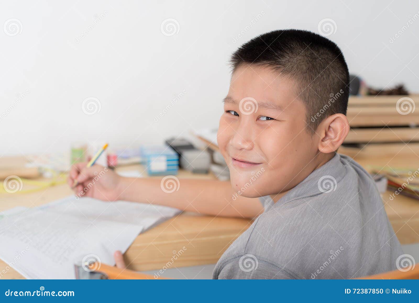 Asian Boy Doing Homework at Home Stock Photo - Image of body, clothes ...