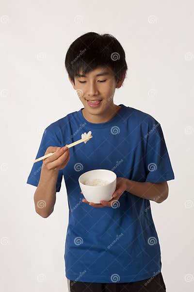 Asian boy eating rice stock photo. Image of enthusiasm - 19431736