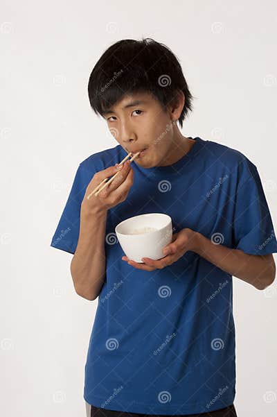 Asian boy eating rice stock photo. Image of teenager - 19431834