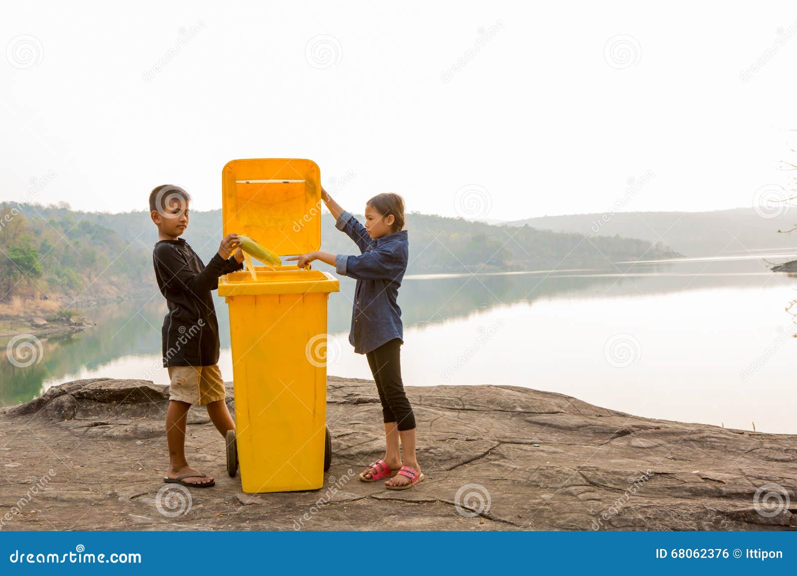 Asian Boy and Girl Throwing Trash into Litter Bin Stock Photo - Image ...