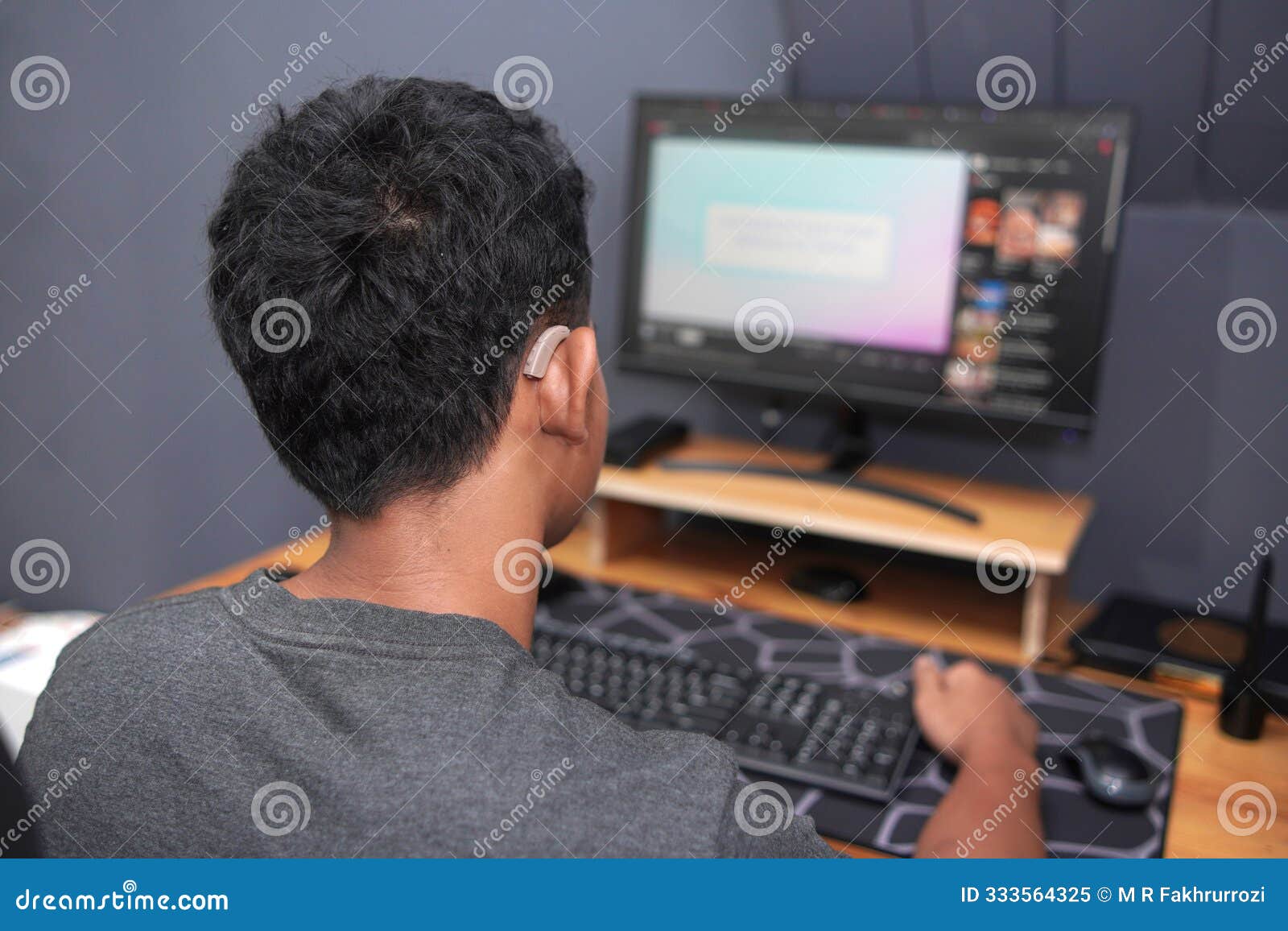 Asian Boy with Hearing Aid Device Using Computer Stock Image - Image of ...