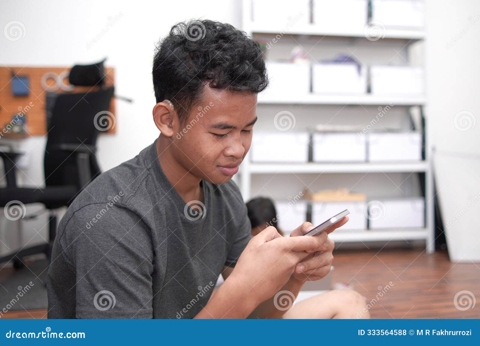 Asian Boy with Hearing Aid Device Using Phone Stock Photo - Image of ...