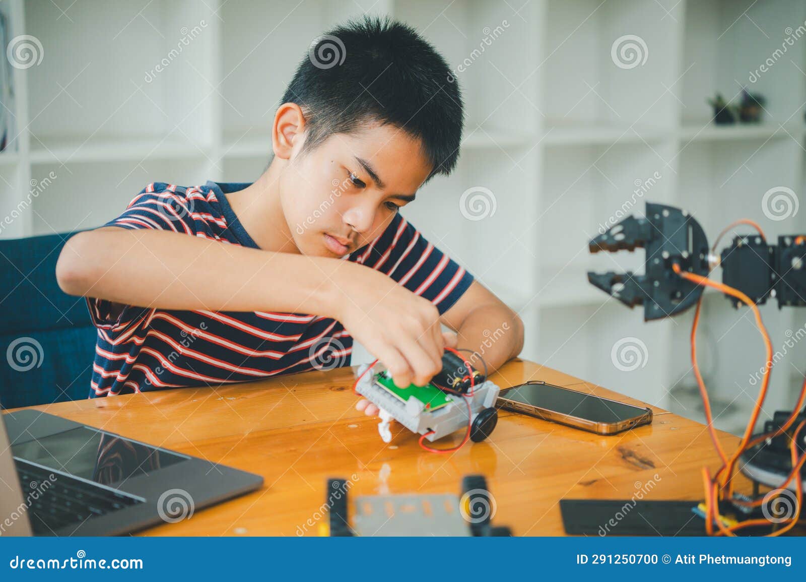 Asian Boy Learning and Studying the Work of Technology Robots ...