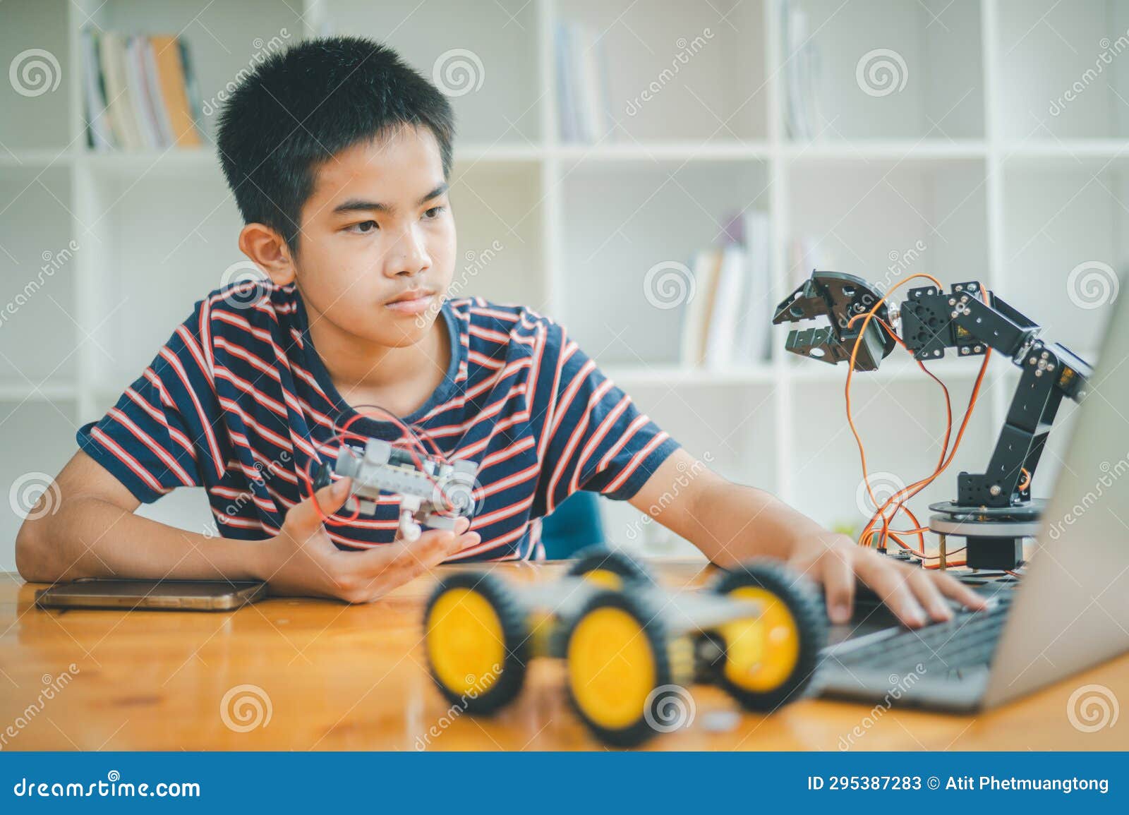 Asian Boy Learning and Studying the Work of Technology Robots ...