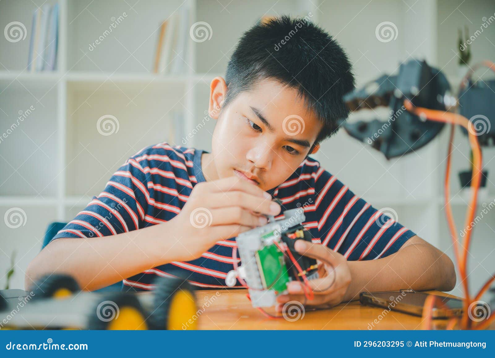 Asian Boy Learning and Studying the Work of Technology Robots ...