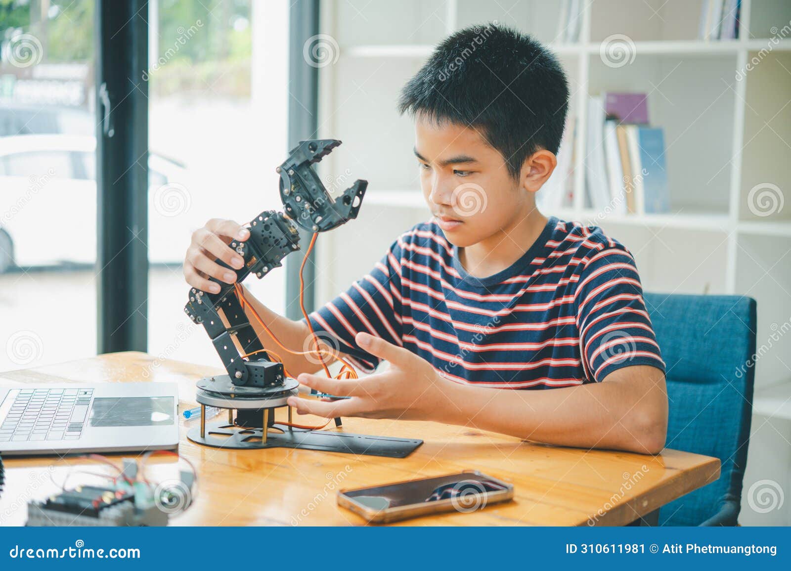 Asian Boy Learning and Studying the Work of Technology Robots ...
