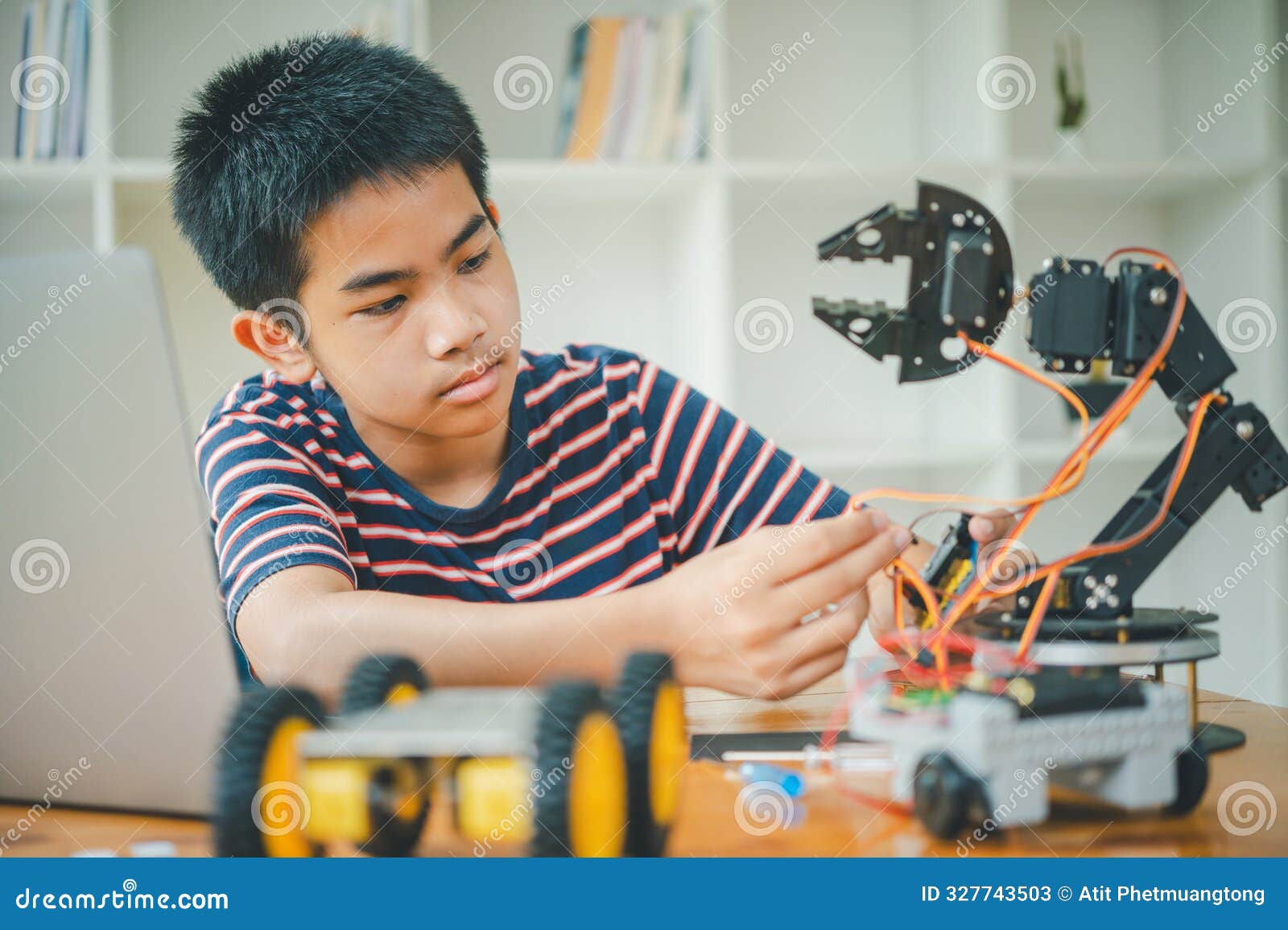 Asian Boy Learning and Studying the Work of Technology Robots ...