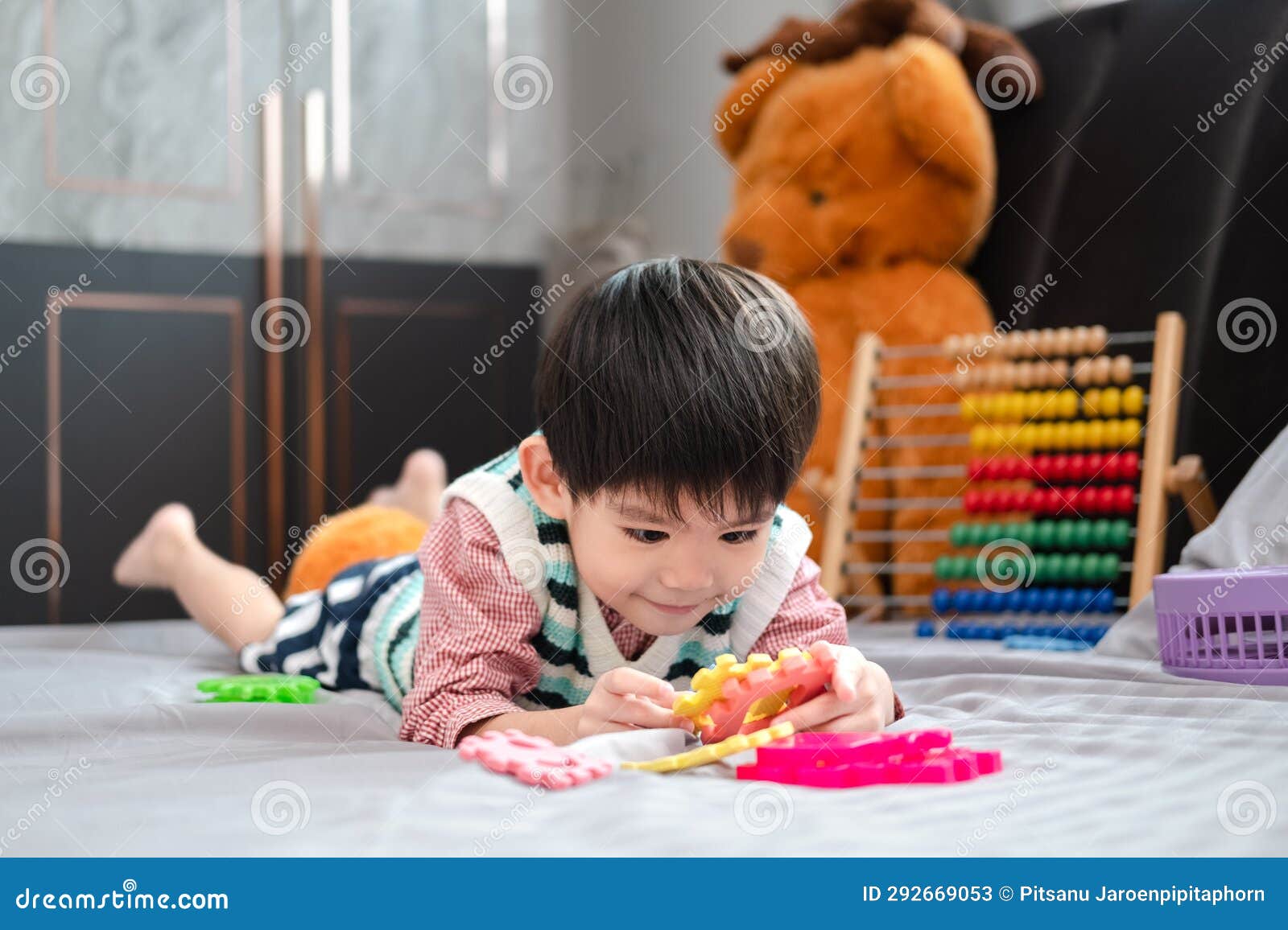 Asian Boy Playing with Jigsaw Puzzles on the Bed Joyfully Stock Image ...