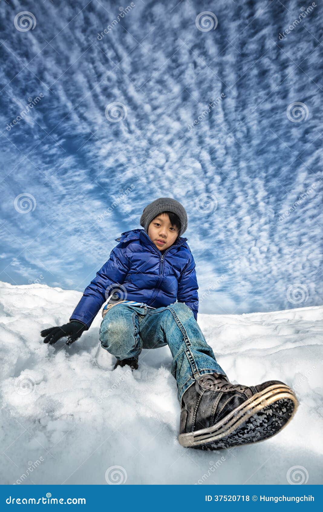 Asian boy playing in snow stock photo. Image of jeans - 37520718