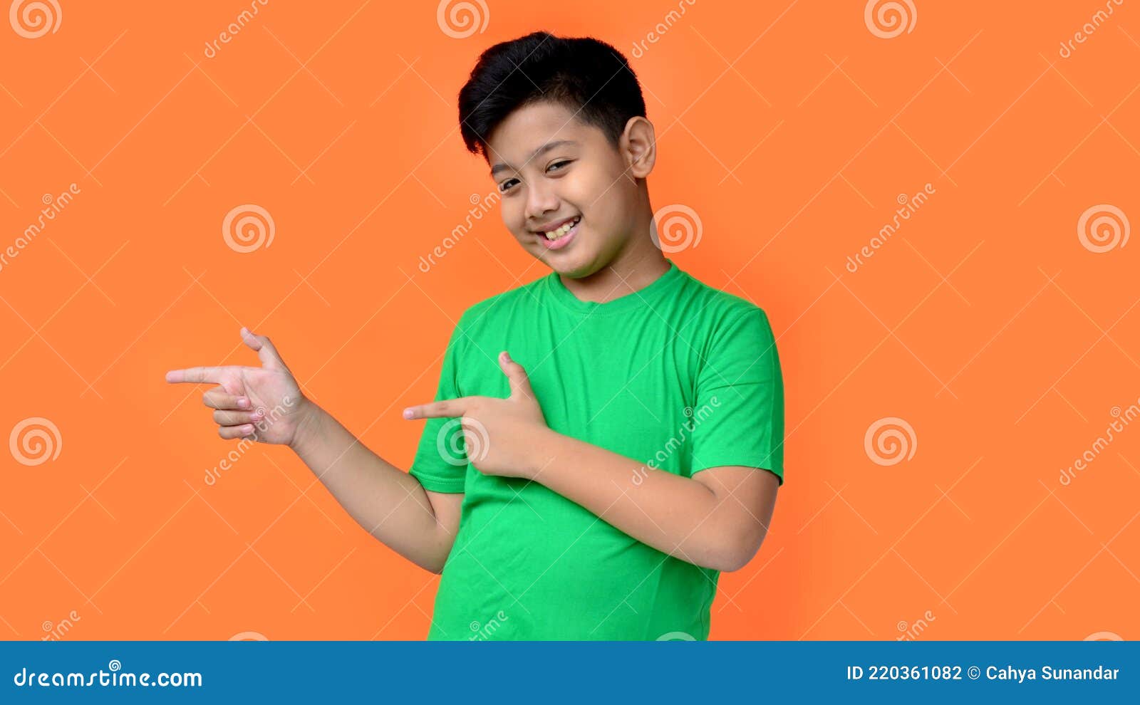Asian Boy with Pointing Something Expression. Isolated at Orange ...
