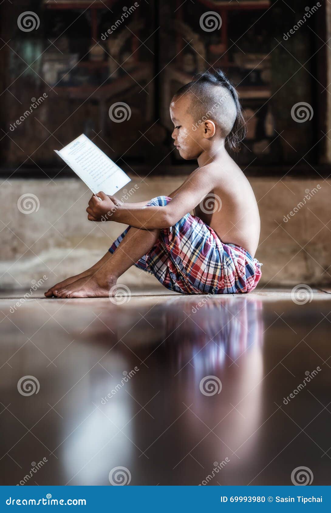 Asian boy reading book stock photo. Image of seating - 69993980