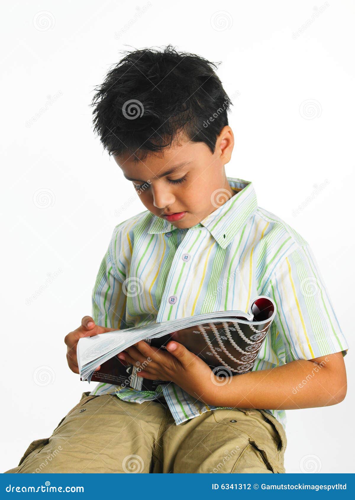 Asian Boy Reading a Magazine Stock Photo - Image of open, holding: 6341312