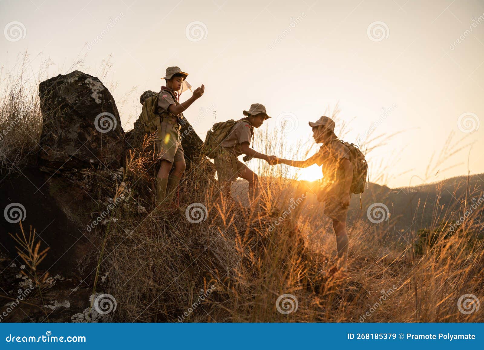 Asian Boy Scouts Help Pull Up from the Cliff. Unity and Teamwork ...