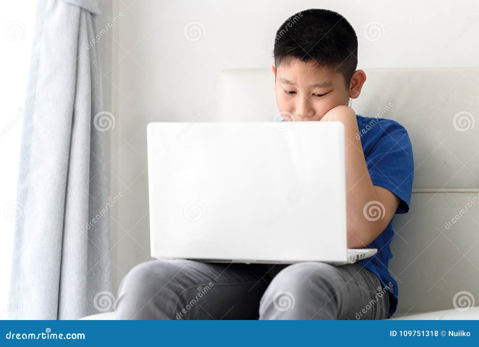 Asian Boy Sitting on Sofa and Using Laptop Stock Photo - Image of home ...