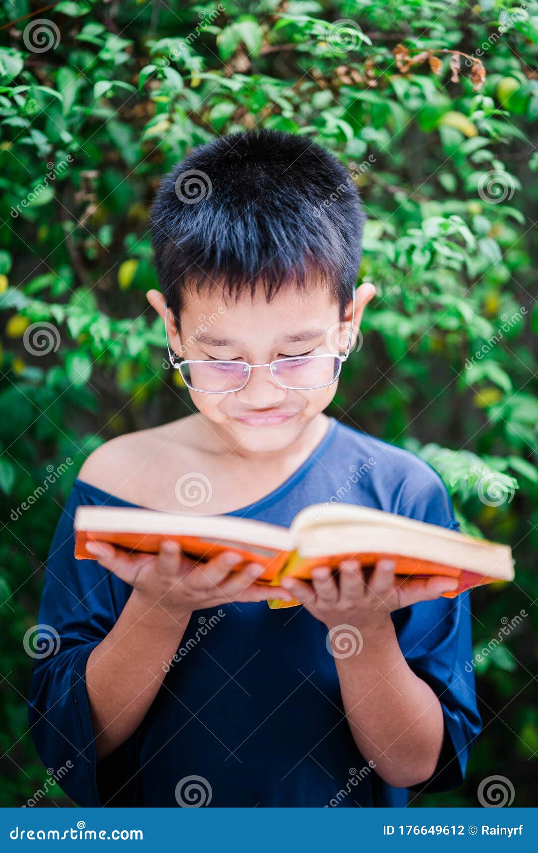 The Asian Boy Stand Reading Book on the Garden Stock Photo - Image of ...