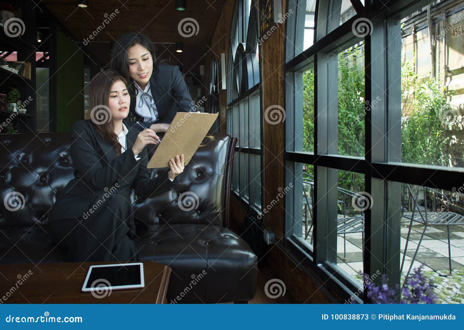 Asian Business Team Discussing Document at Coffee Shop Stock Image ...
