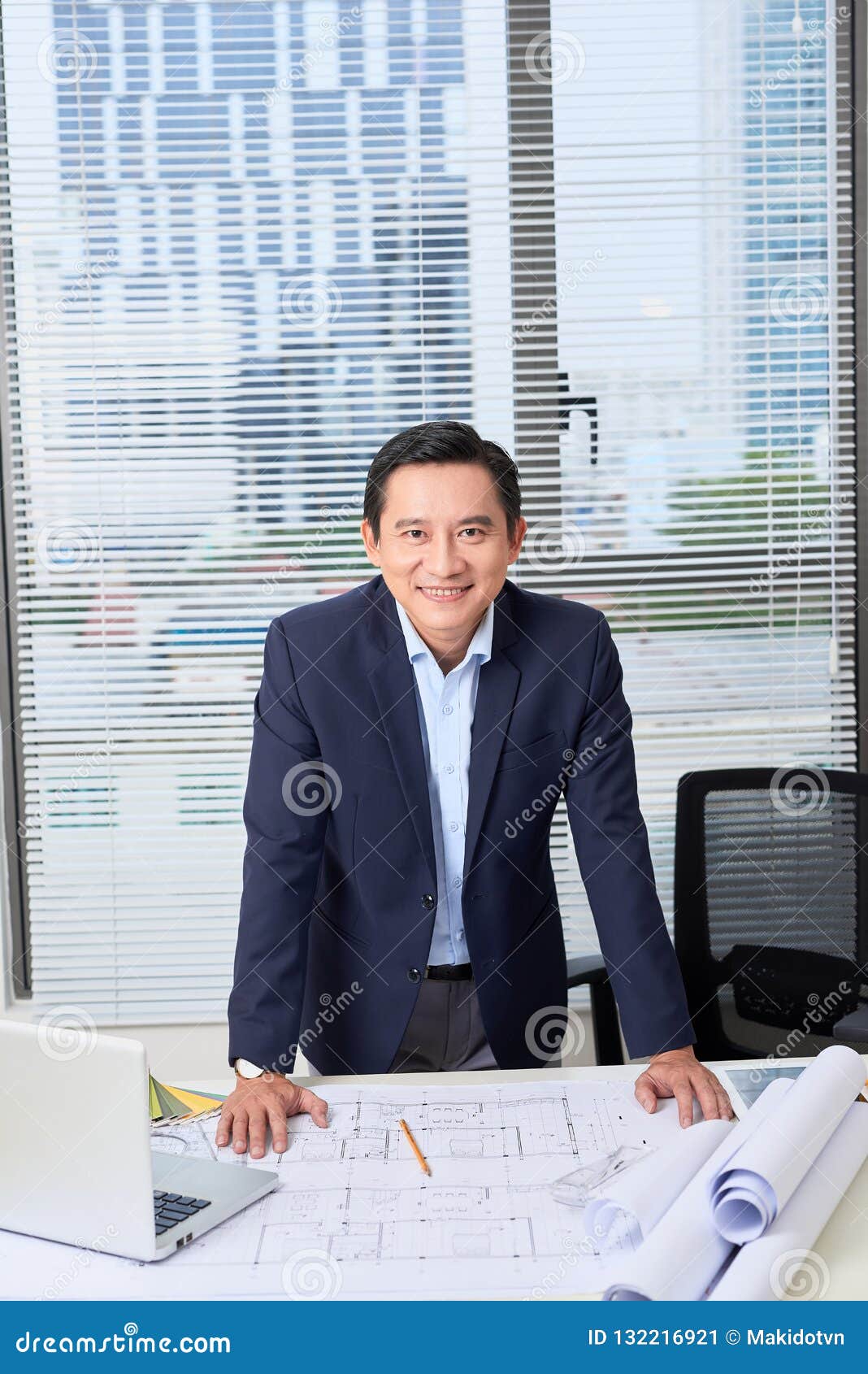 Asian Businessman, an Engineer with the Work Plan, Standing in T Stock ...