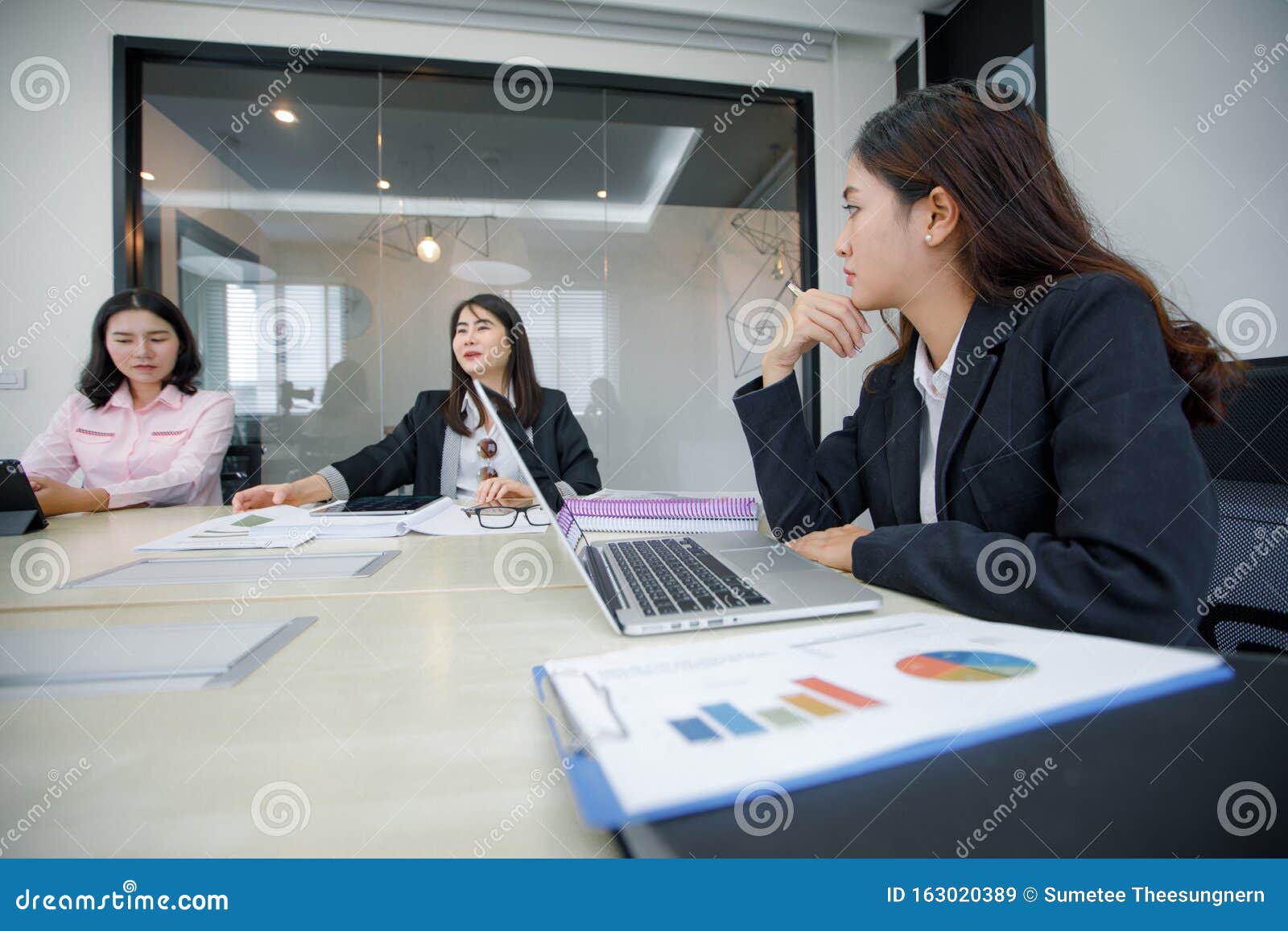 Asian Businessmen and Group Using Notebook for Meeting Serious about ...