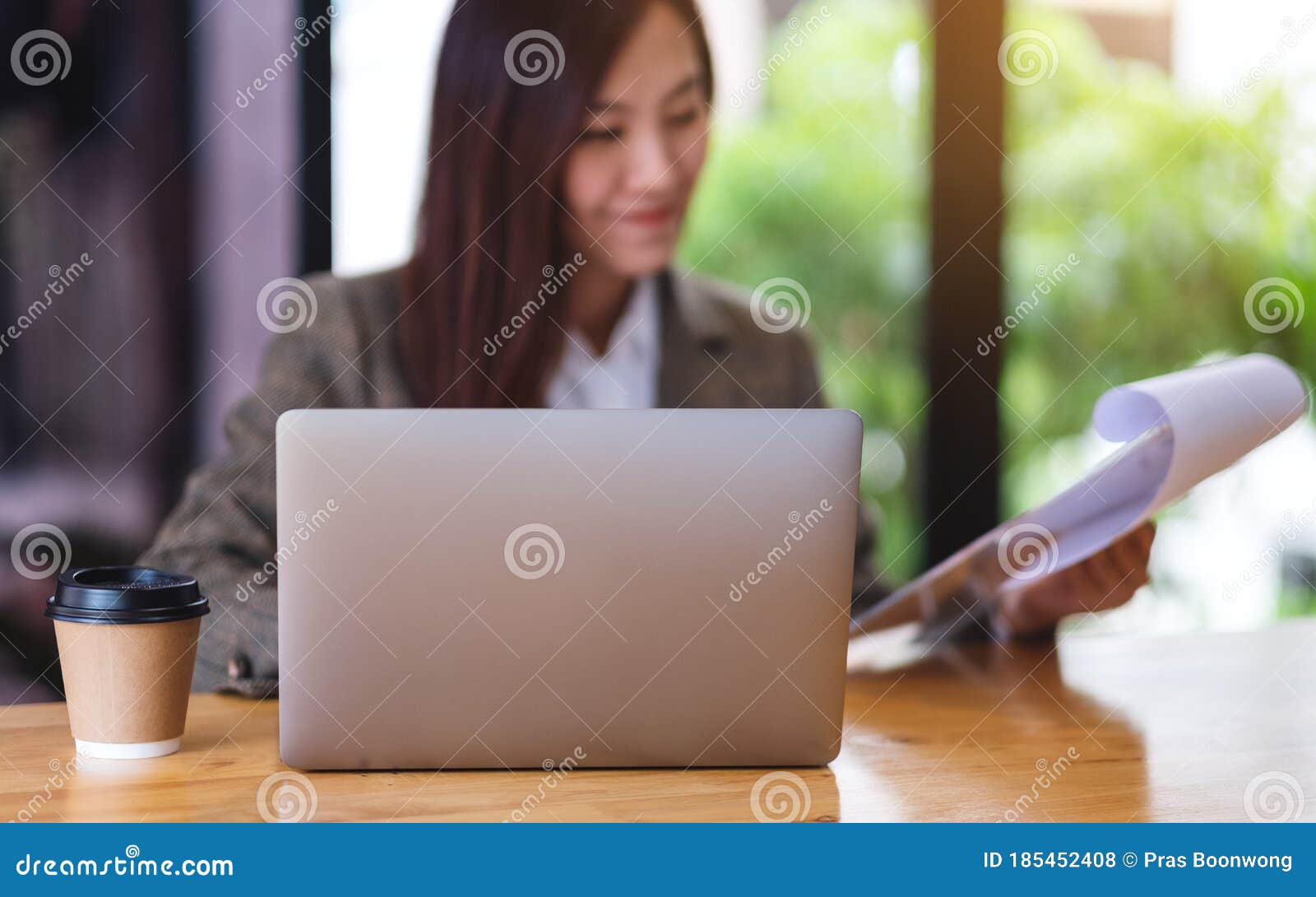An Asian Businesswoman Using Laptop Computer while Working in Office ...