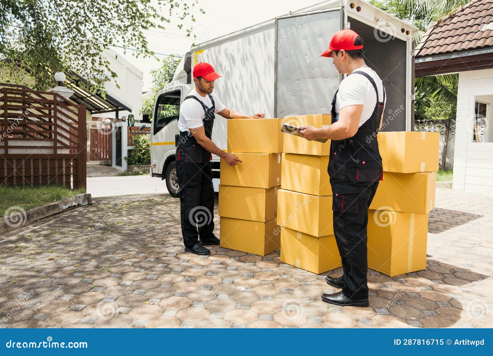 Asian and Caucasian Workers in Uniform Unloading Cardboard Boxes from ...