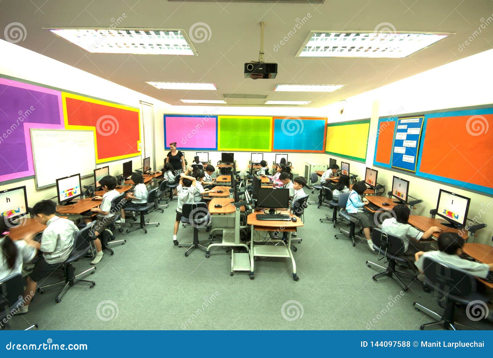 Asian Elementary Child Learning To Use Computer in Classroom. Editorial ...
