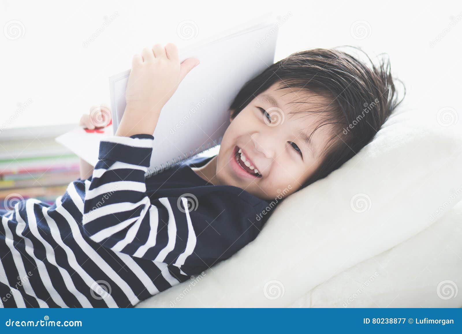 Asian child reading a book stock image. Image of home - 80238877