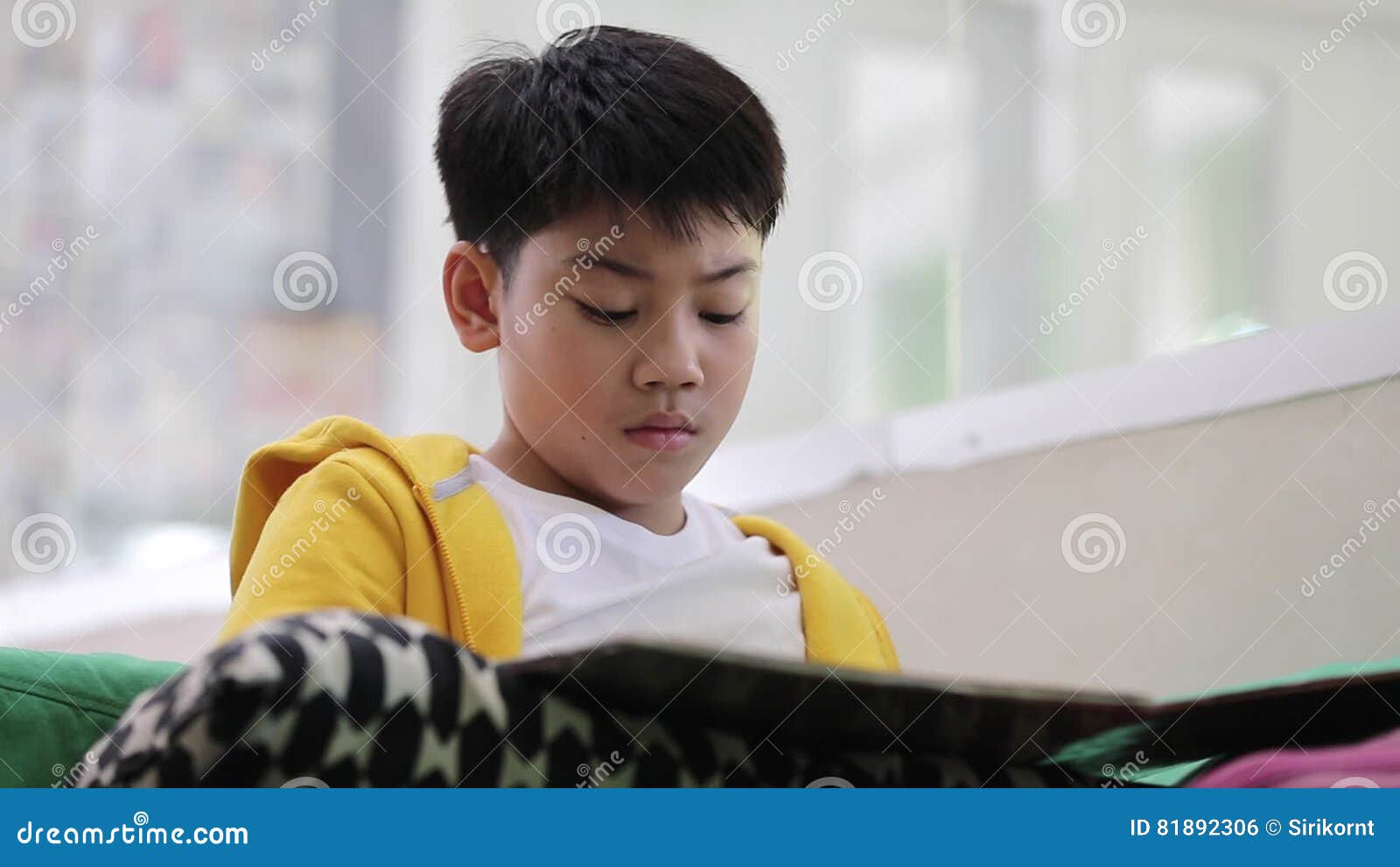 Asian Child Reading and Writing To Do Homework of the School . Stock ...