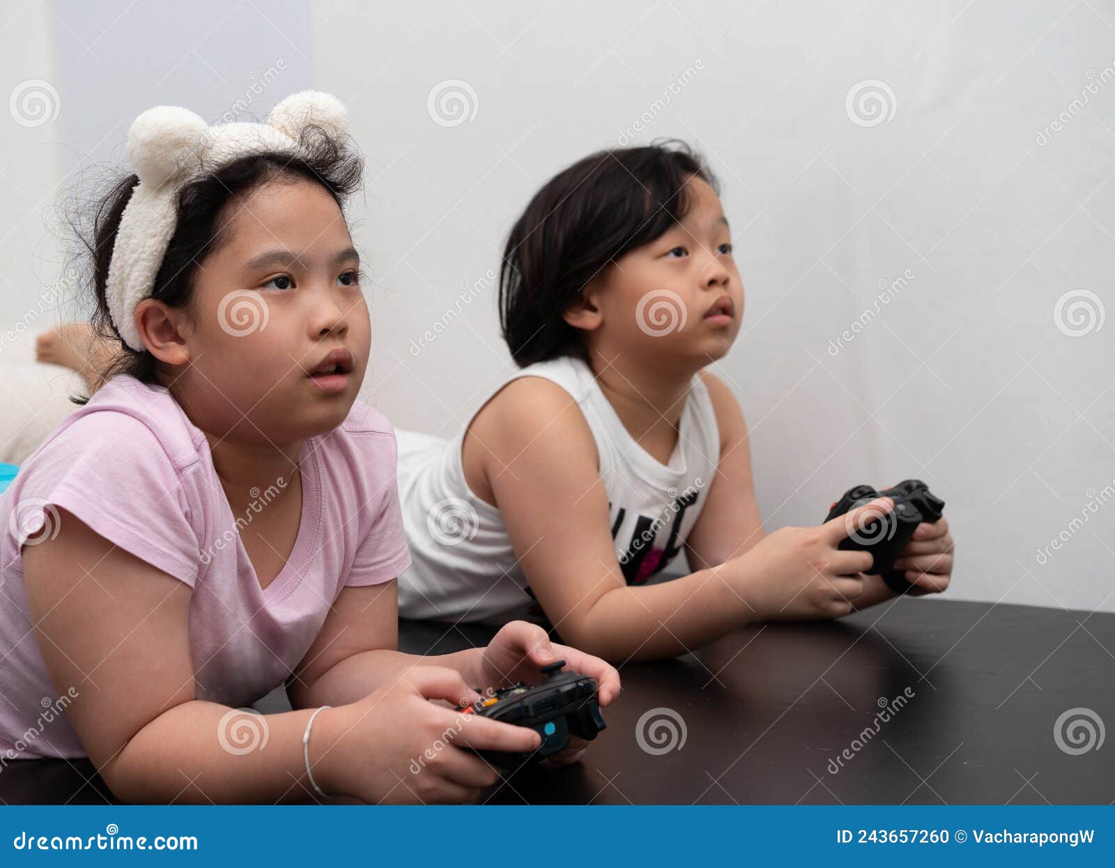 Asian Children Play Video Game by Controller in Home Stock Photo ...