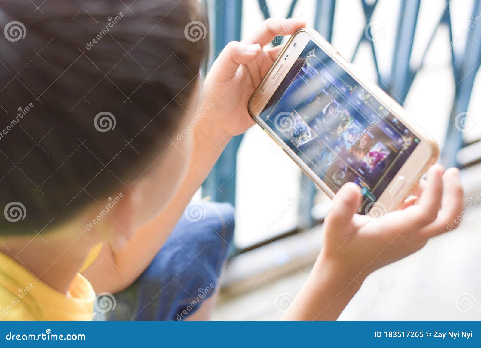 Asian Chinese Little Boy Playing Mobile Legends Game. Using Smart Phone ...