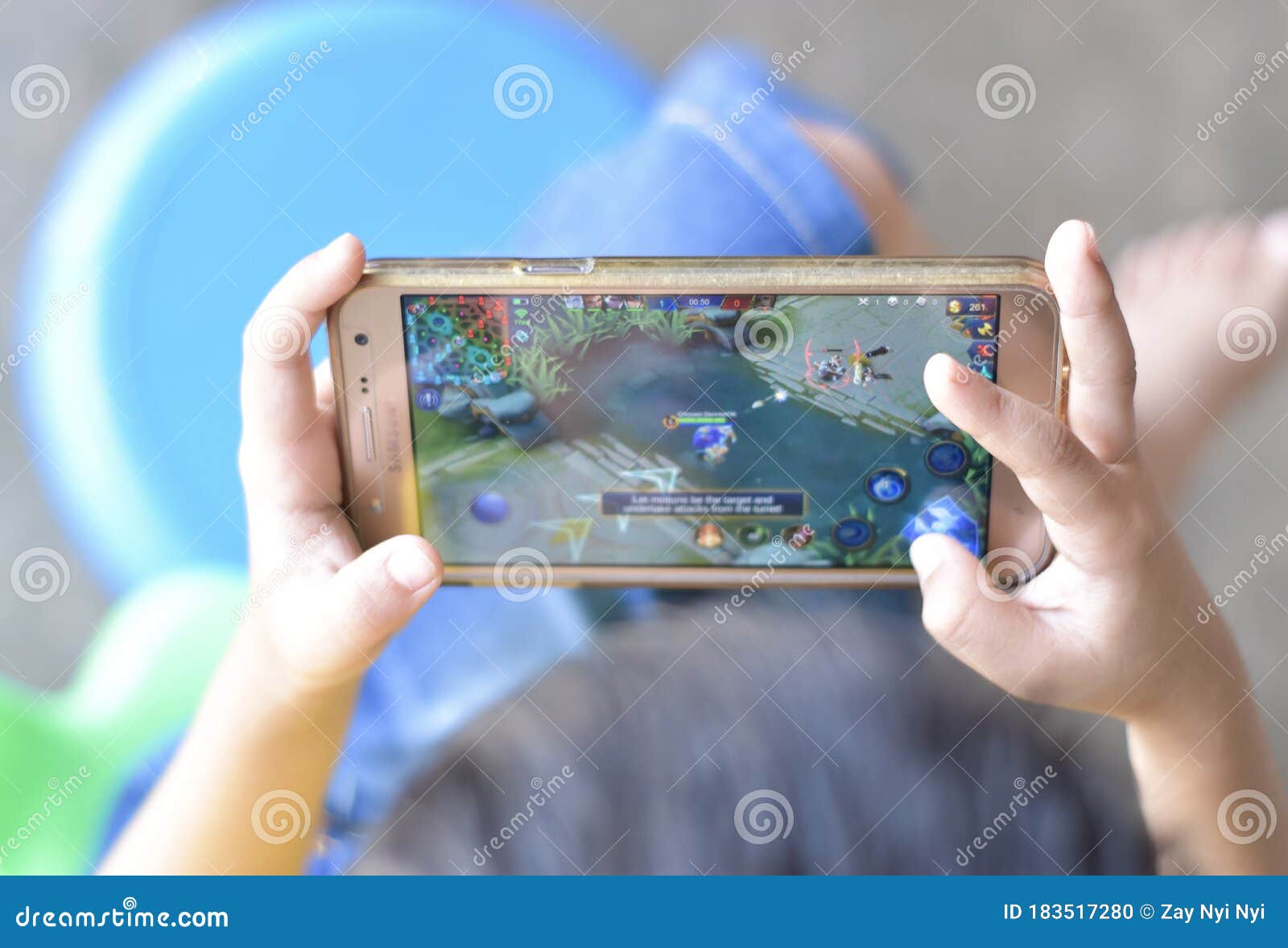 Asian Chinese Little Boy Playing Mobile Legends Game. Using Smart Phone ...