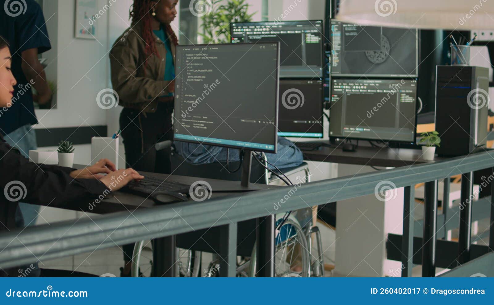Asian Coder with Physical Disability Working with African American ... Asian Coder with Physical Disability Working with African American ...