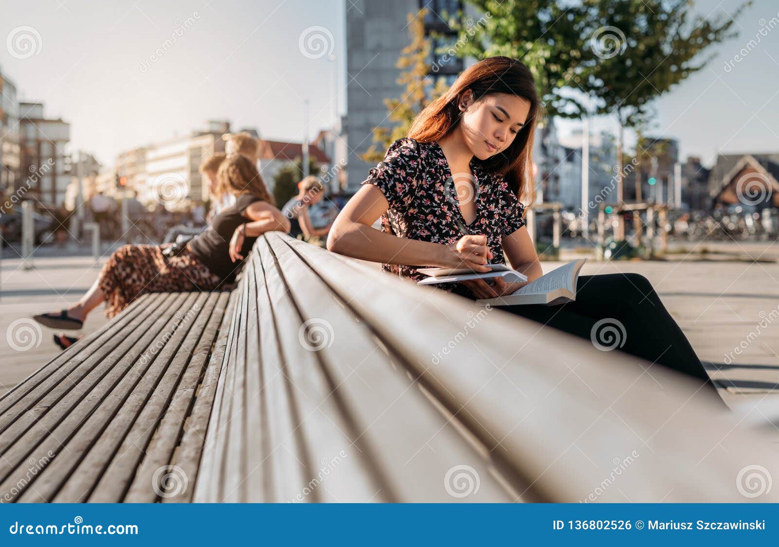 Asian College Student Sitting on a Campus Bench Studying Stock Photo ...