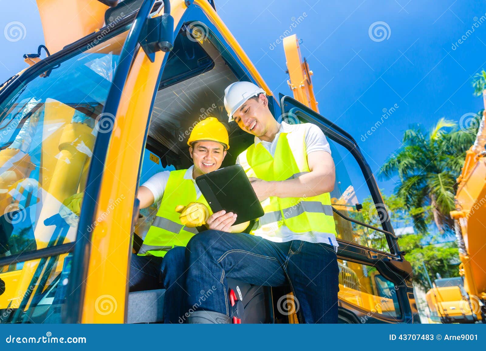 Asian Construction Driver Discussing with Engineer Blueprints Stock ...