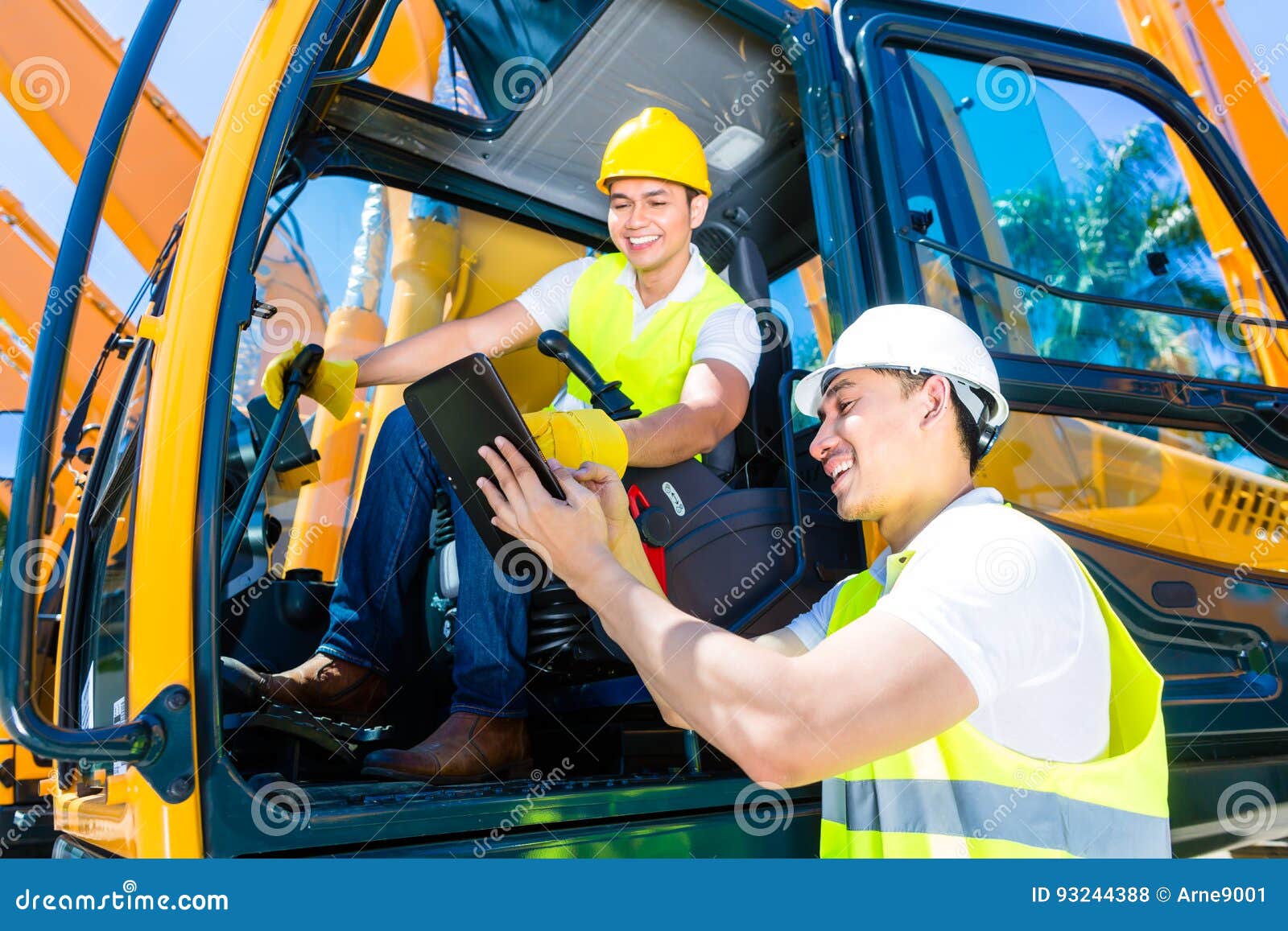 Asian Construction Driver Discussing with Engineer Blueprints Stock ...