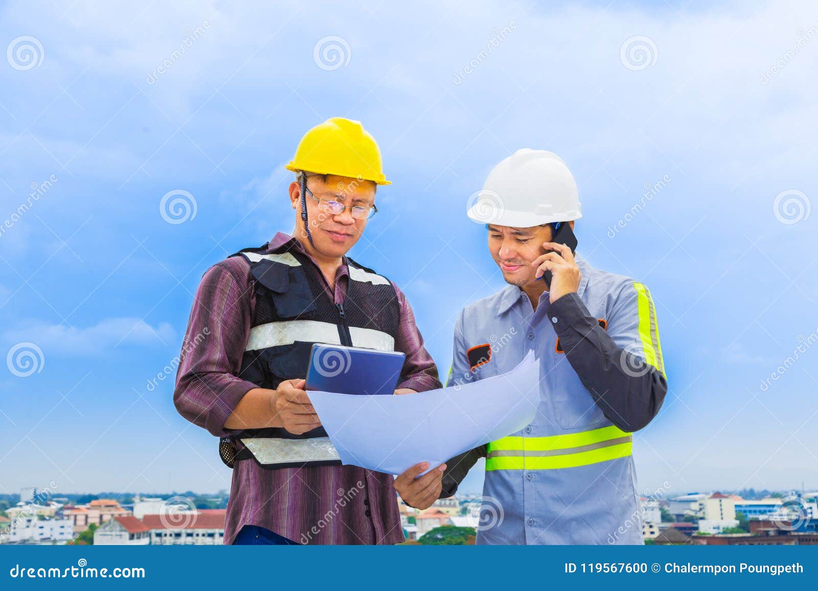 Asian Construction Engineer Talking on the Phone while Working W Stock ...