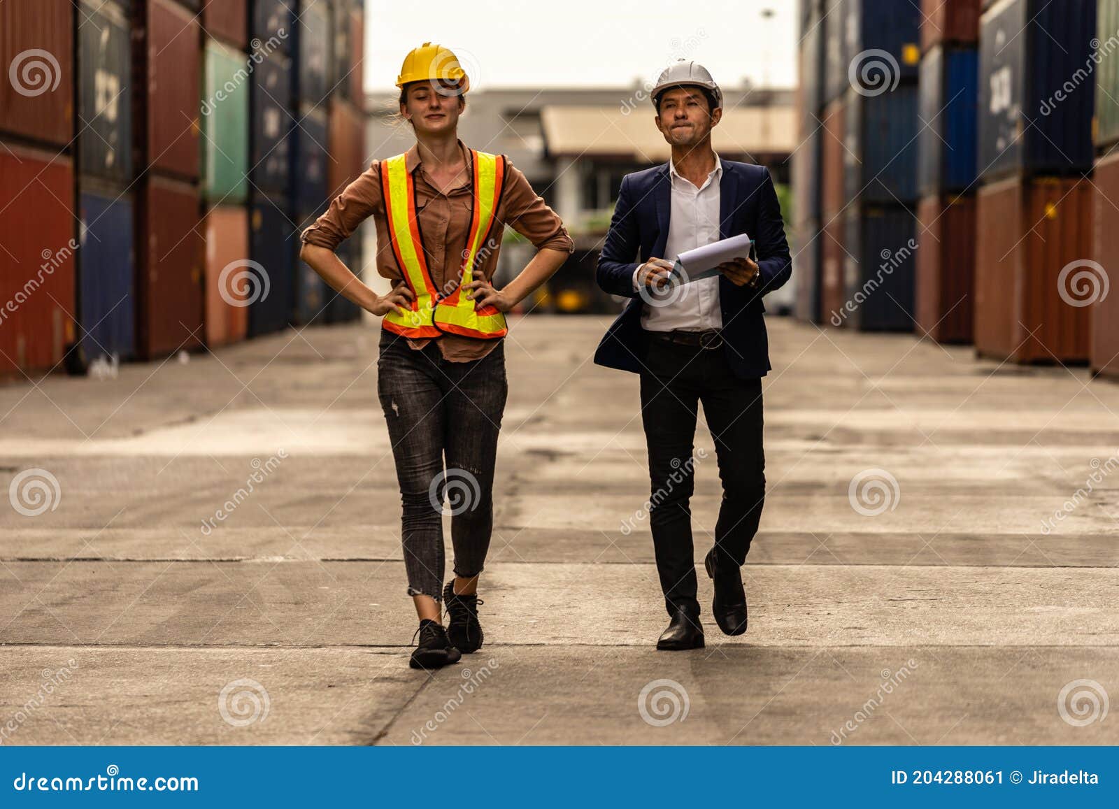 Asian Container Yard Manager and Female Foreman Walking through the ...