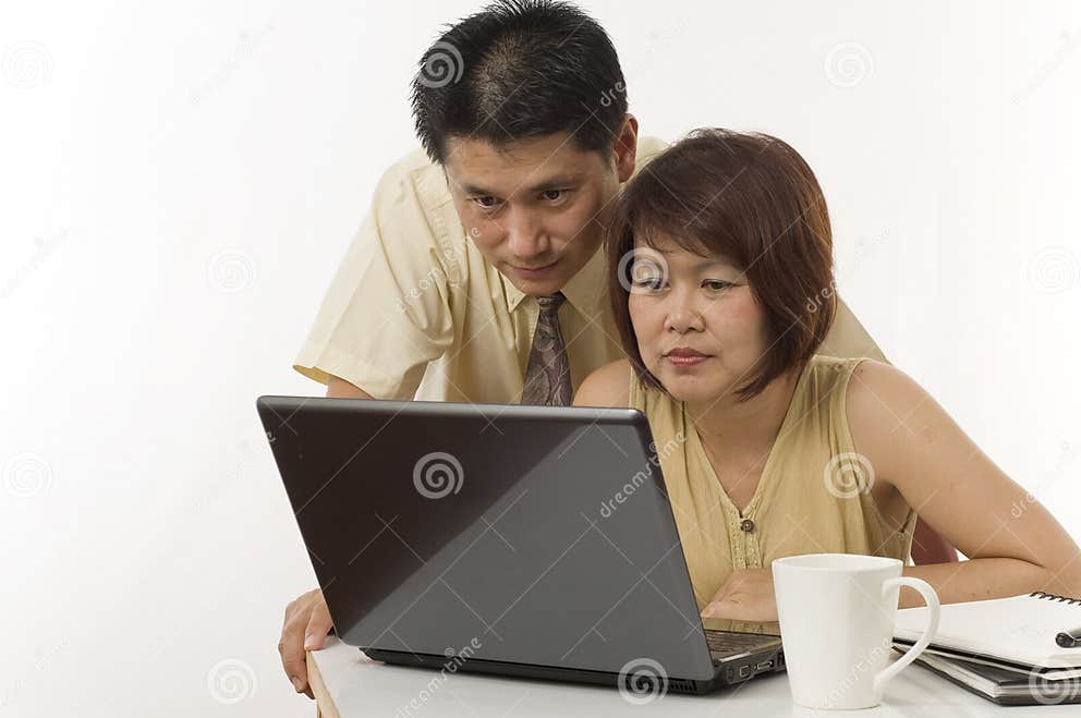Asian couple with computer stock image. Image of home - 15435455