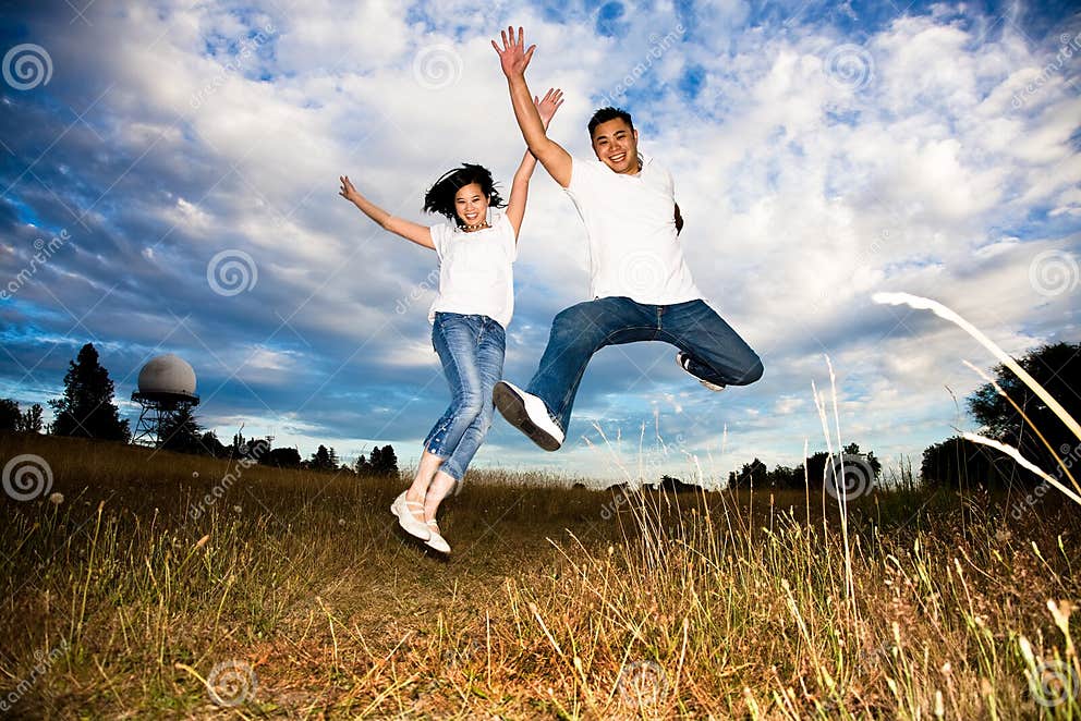 Asian Couple Jumping for Joy Stock Image - Image of love, laugh: 6493161