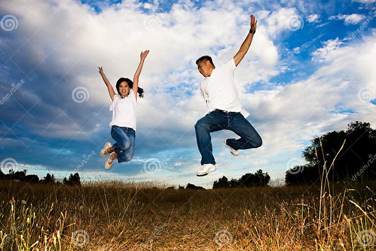 Asian Couple Jumping for Joy Stock Image - Image of asian, beautiful ...