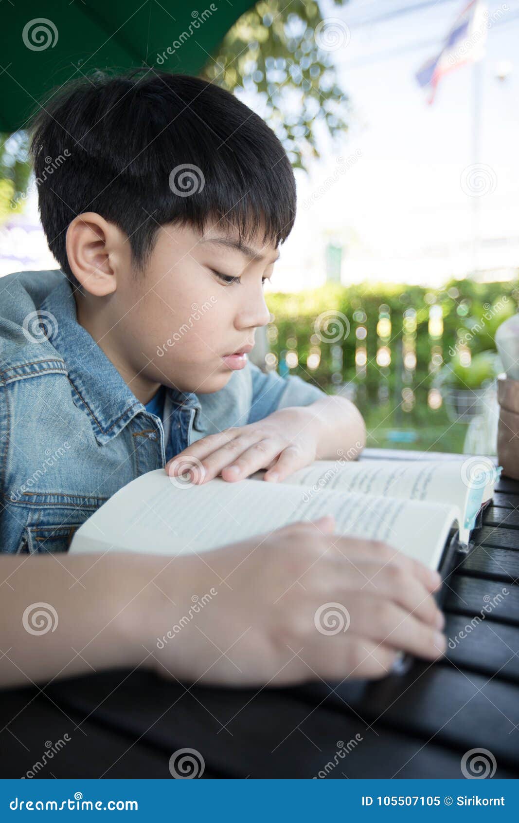 Asian Cute Little Boy Reading Book with Serious Face . Stock Image ...