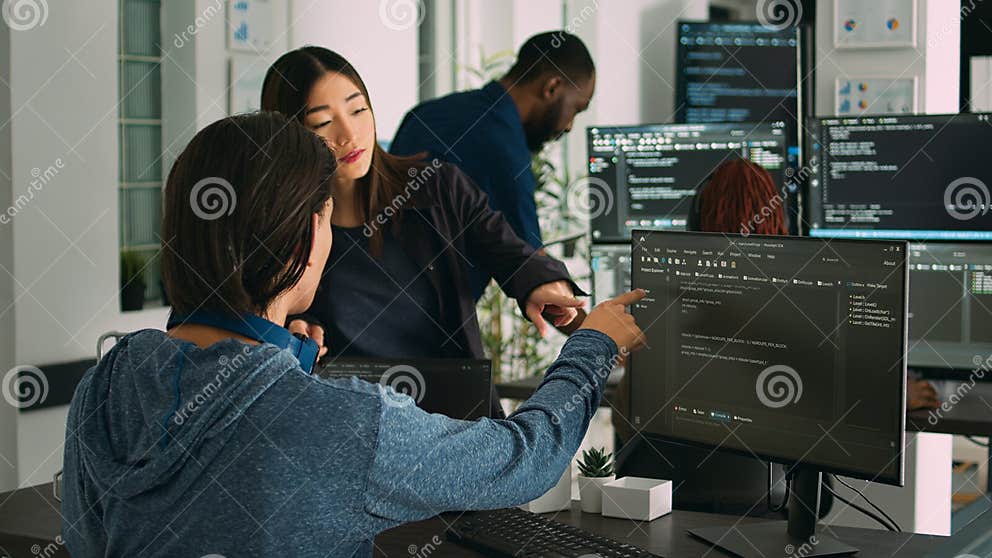 Asian Database Developers Analyzing Compiling Code on Multiple Screens ...