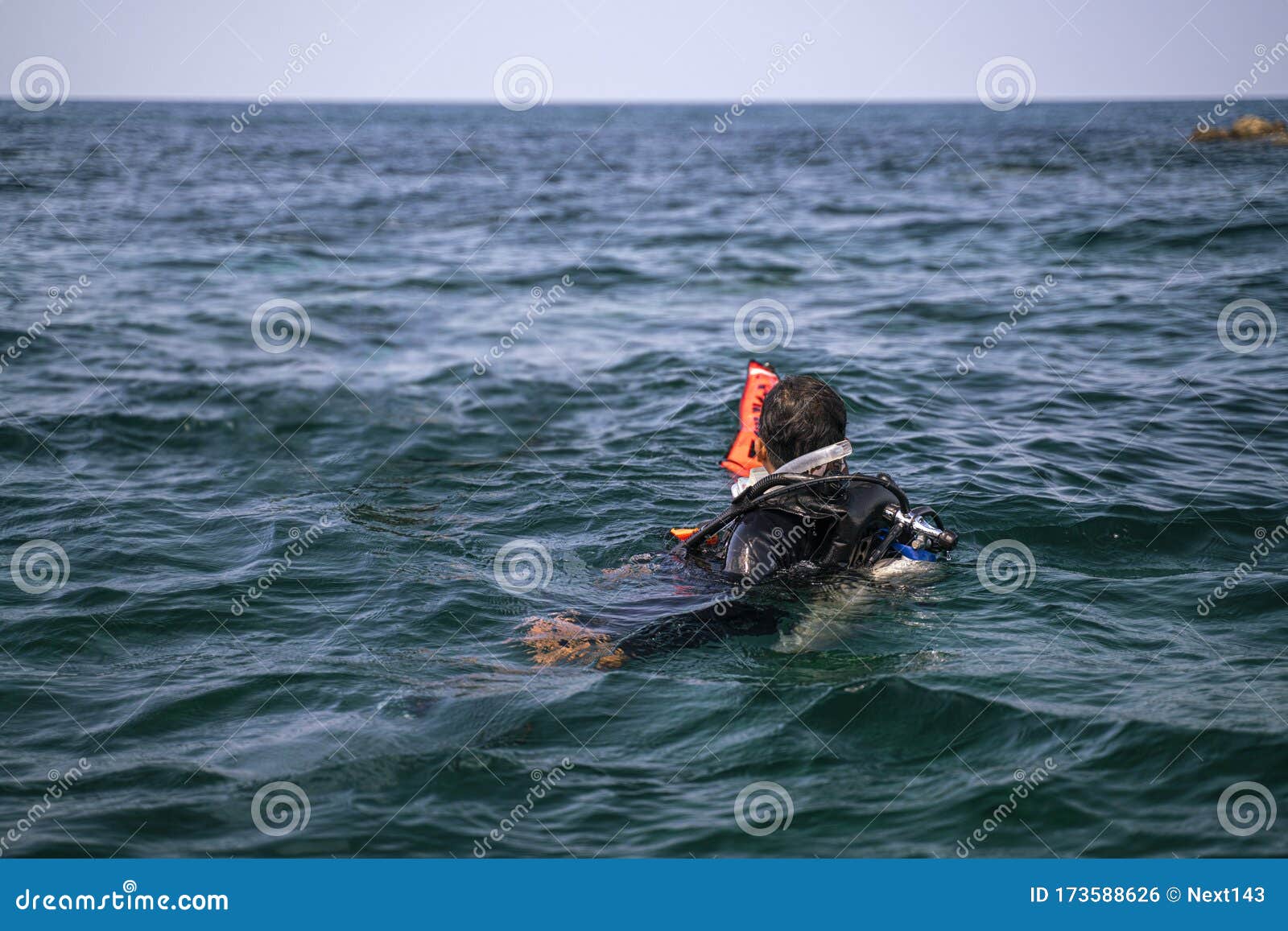 An Asian Diving Man Look Forward To the Coast Line Floating on the Sea ...